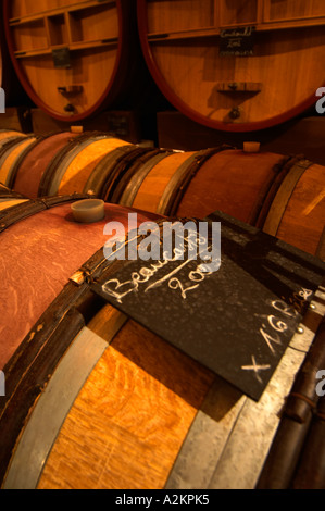 The aging cellar with oak barrels and larger wooden vats. Chateau de ...