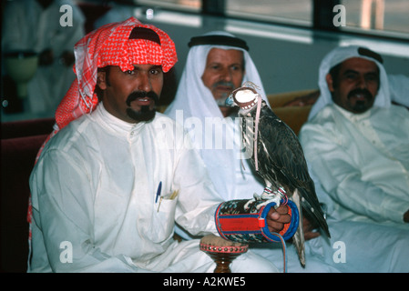 Arab falconer with hooded falcon Bahrain Airport Middle East Stock ...