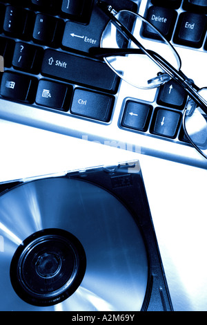 Eyeglasses on computer keyboard and Cd Stock Photo - Alamy
