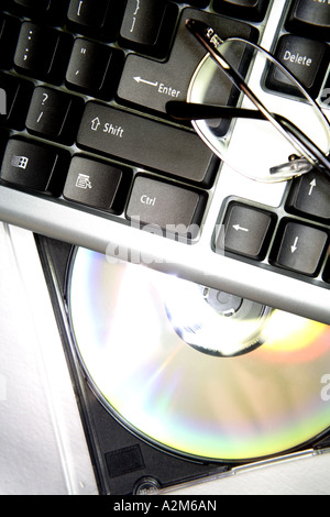Eyeglasses on computer keyboard and Cd Stock Photo - Alamy