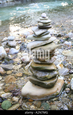 A selective focus shot of pebbles on the beach and a wave on blurred ...