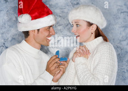 Side profile of a young man proposing a young woman Stock Photo - Alamy