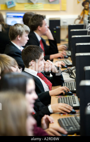 Secondary school pupils looking at a computer screen in the school ...