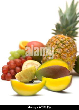 A selection of exotic fruit whole and sliced on a white background ...