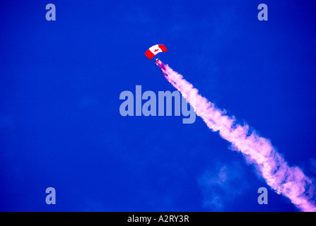 A skydiver parachutes trailing the American flag prior to the NCAA ...