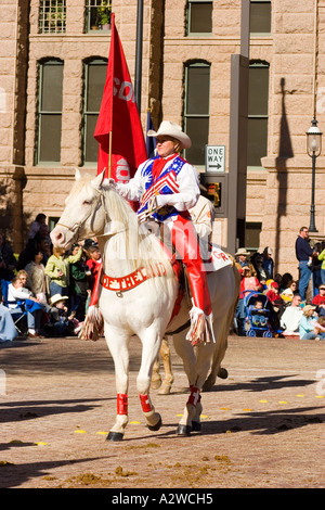 Rodeo cowgirl riding horse carrying American flag during the 4th Stock ...