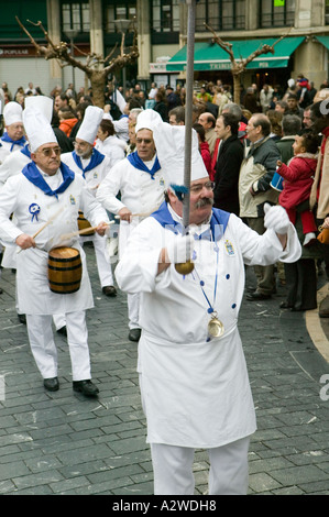Basque men wearing white chefs outfits drumming on wooden barrels, La ...