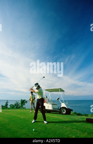Philippines. Luzon. Bataan. Anvaya Cove. Men playing golf Stock Photo ...