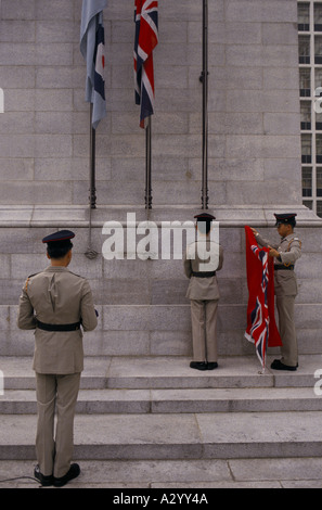 Man lowering British Union Jack flag in Hong Kong Stock Photo - Alamy