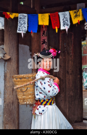 Matriarchal Mosuo woman by the door with praying flags Lugu Lake ...