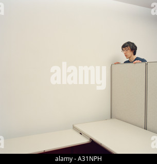 Man peeking over cubicle wall Stock Photo - Alamy
