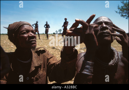 A chief of an indigenous Himba people tribe and his wife are posing in ...
