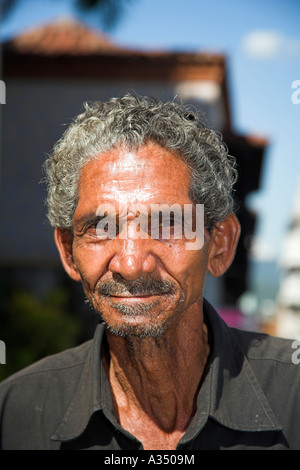An elderly man with curly gray hair and a beard playfully ruffles his ...
