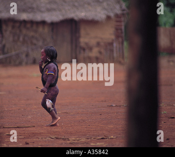 A Ukre village Brazil Kayapo child with black body paint and blue Stock ...