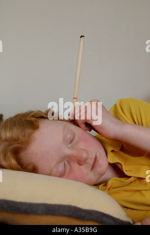 Hopi ear candle therapy Stock Photo - Alamy
