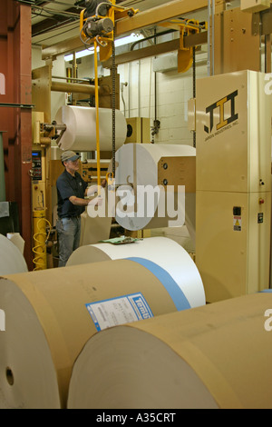 Worker loading paper rolls in to lorry with forklift Stock Photo - Alamy