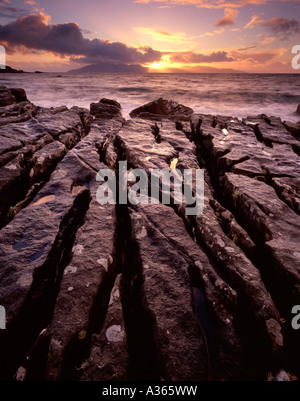 A sunset view over a small loch near Achnahaird beach, Scotland with ...