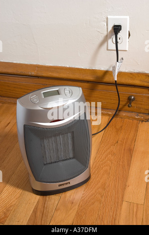 Electric heater plugged in Stock Photo - Alamy