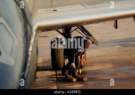 Ground crew removing wheel chocks from A380 aircraft at night Stock ...