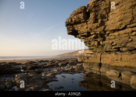 A highly stratified limestone and shale sea cliff in warm evening light ...