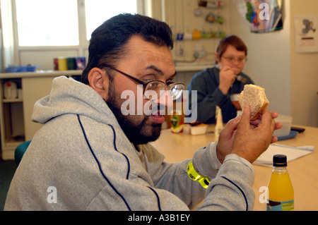 Disabled man eating his lunch Stock Photo - Alamy