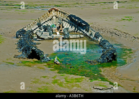 Derelict wooden boat on sandy beach. Rampside, Morecambe Bay, Cumbria ...