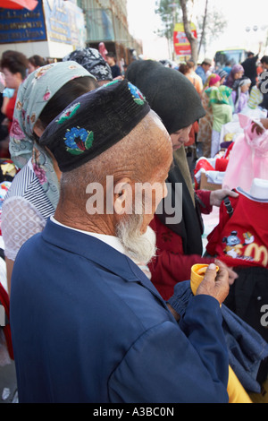 Close-up of an elderly Uighur man with a beard wearing a doppa in Qiemo ...