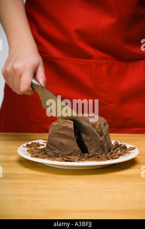 Woman cutting block of chocolate Stock Photo - Alamy
