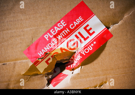 a damaged box with the fragile sticker on it Stock Photo - Alamy
