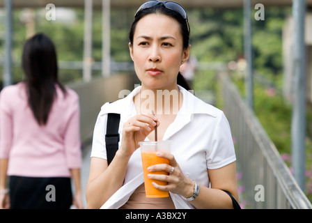 Young Thai businesswoman takes a lunchtime stroll Stock Photo - Alamy