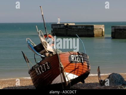 A traditional clinker built fishing boat drawn up on Walmer beach Kent ...