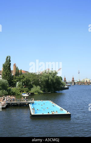 Crowded outdoor swimming pool full of people bathing in Germany, on a ...