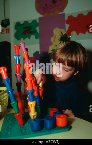 Young girl and boy building a tall, colorful block tower togethe Stock ...