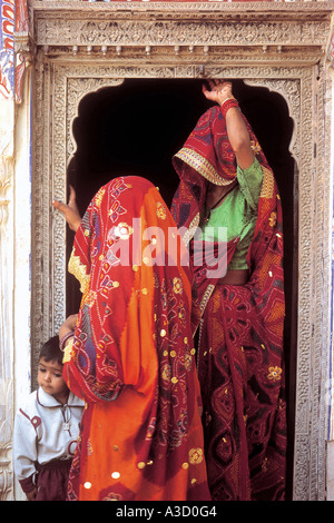 Two Rajasthani women in ghunghat veil ; Jaisalmer ; Rajasthan ; India ...