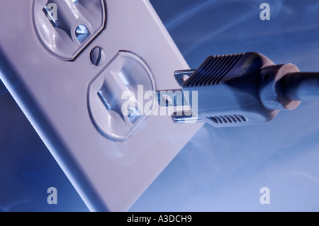 electrical plug moves through smoky space toward an empty electical ...