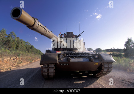 Army tank with gun pointing over camera, soldier directing driver ...