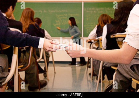 High school students passing notes in class Stock Photo: 28080312 - Alamy