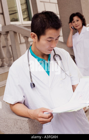 Asian women doctor talking phone consultation medical professional ...