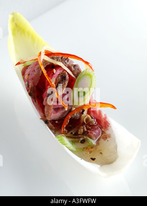 Beef canape in a chicory leaf editorial food Stock Photo - Alamy