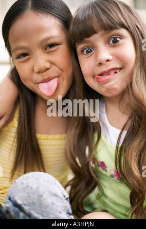 Cute girls making funny faces Stock Photo - Alamy