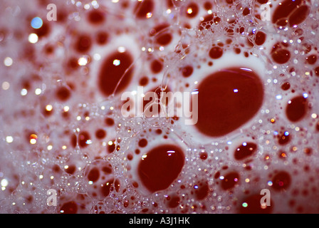 Red bathwater with bubbles Stock Photo - Alamy