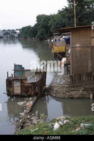 outside toilet built over the river near a shack in a slum area of ...