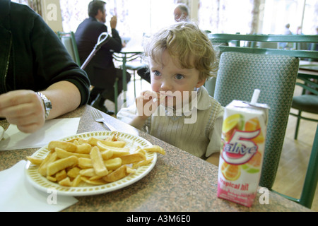 Lewis aged two eating his lunch in a cafe Stock Photo - Alamy