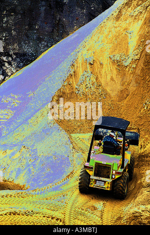 backhoe tractor moves sand gravel around large construction pit Stock ...