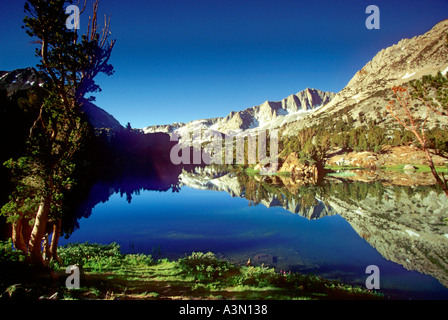 The peaks around Bishop Pass reflected in Long Lake Inyo National ...