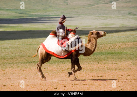Mongolian nomad riding on a camel in the Gobi desert in the wintertime ...
