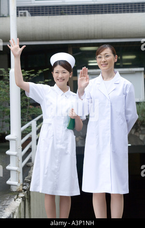 Doctor woman or nurse in a hospital office with her colleague and ...