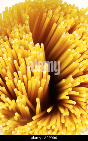 Pile of various uncooked dry pasta in wicker basket and wooden bowls ...