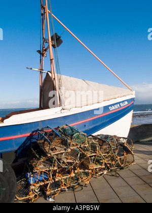 Yorkshire coble fishing boat with lobster pots on a bright winters day ...
