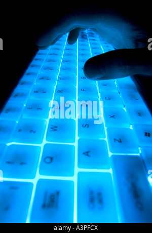 hands typing on blue backlit keyboard Stock Photo - Alamy